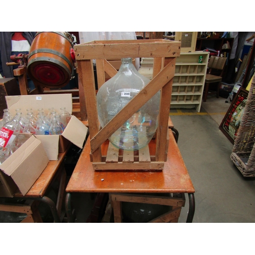 Five glass carboys in wooden packing crates