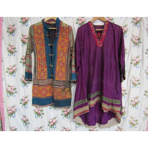 Four items of Asian tribal clothing to include two tunics and two jackets
