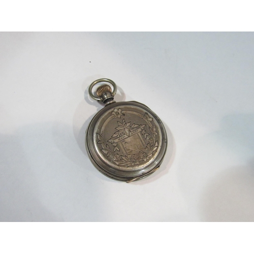 A silver fob watch with engraved detail