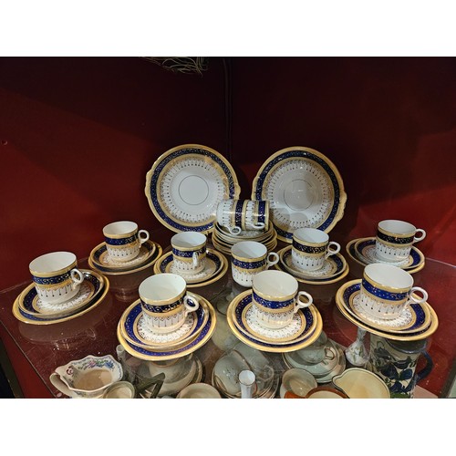 A china tea set, white ground, blue/yellow rims, gilt embellishment ...