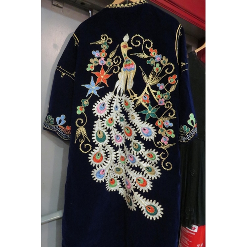 A velvet evening cocktail coat with eleborate embroidery of peacock and ...