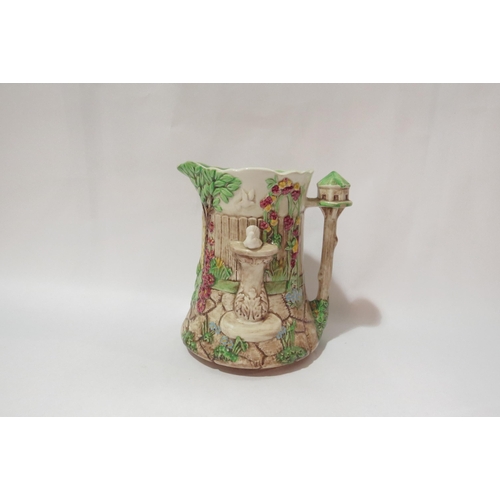 A Falcon Ware jug, handle as dovecote, decorated in high relief with ...
