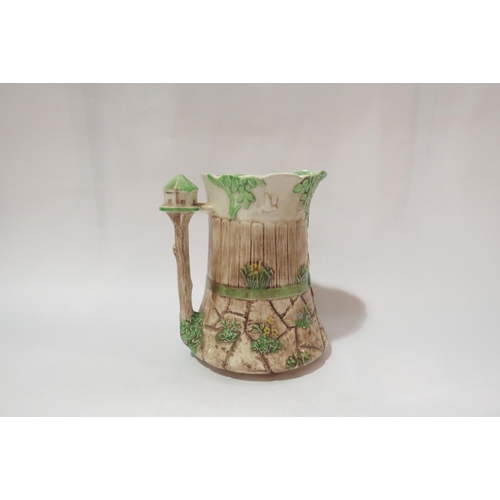 A Falcon Ware jug, handle as dovecote, decorated in high relief with ...