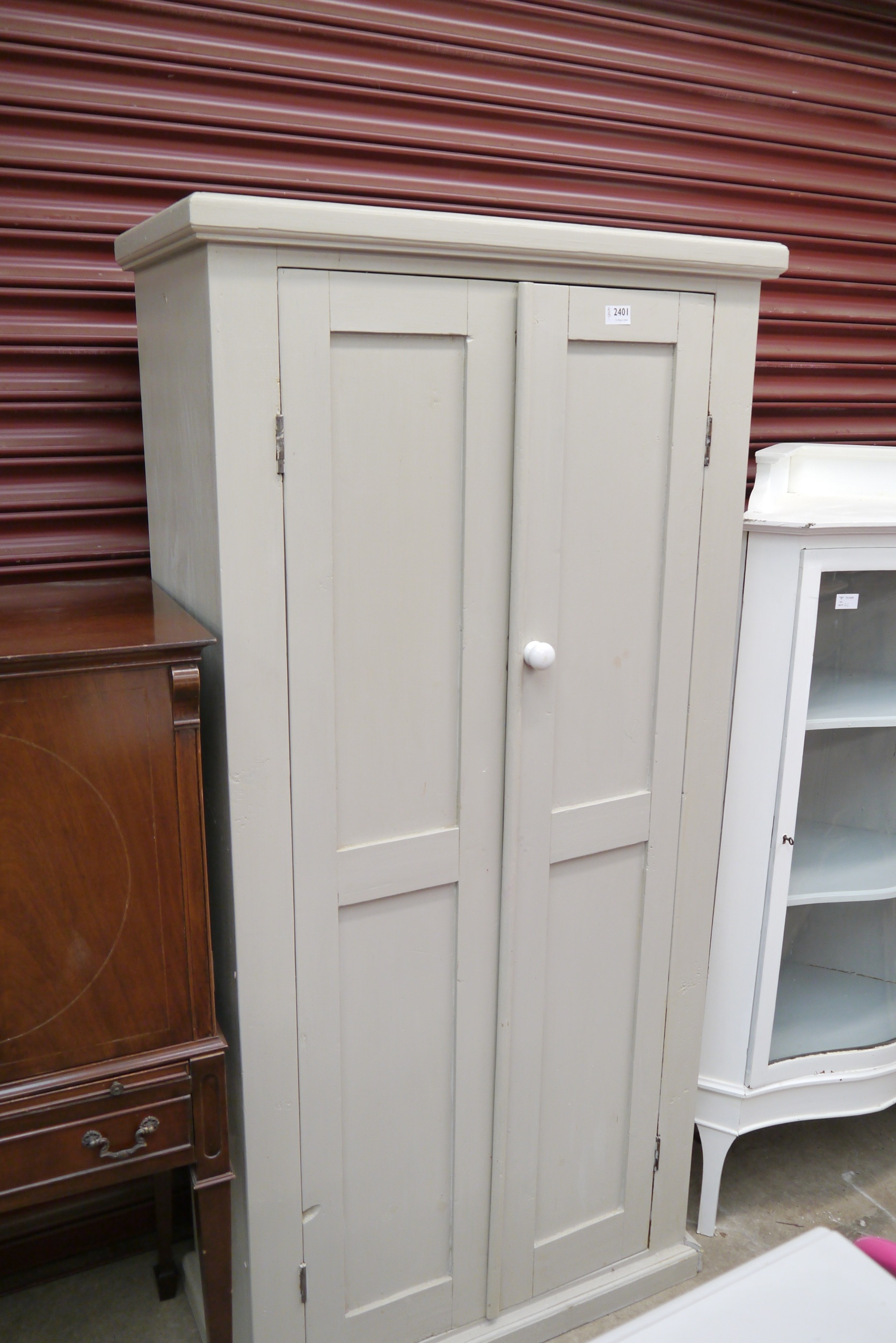 A grey painted pine housekeeper's cupboard, plinth base