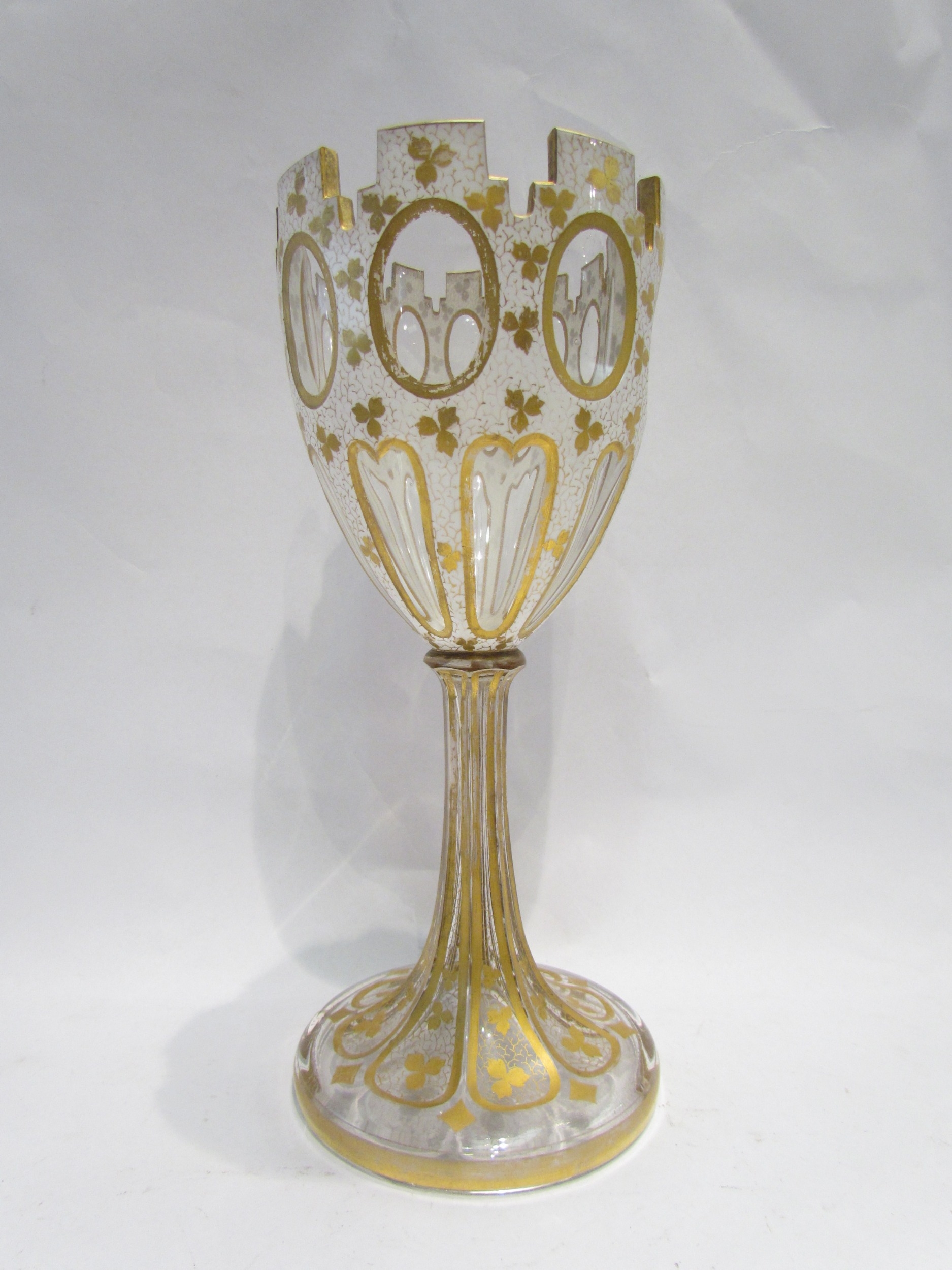 A Victorian glass goblet vase with white and gilt floral leaf detailing ...
