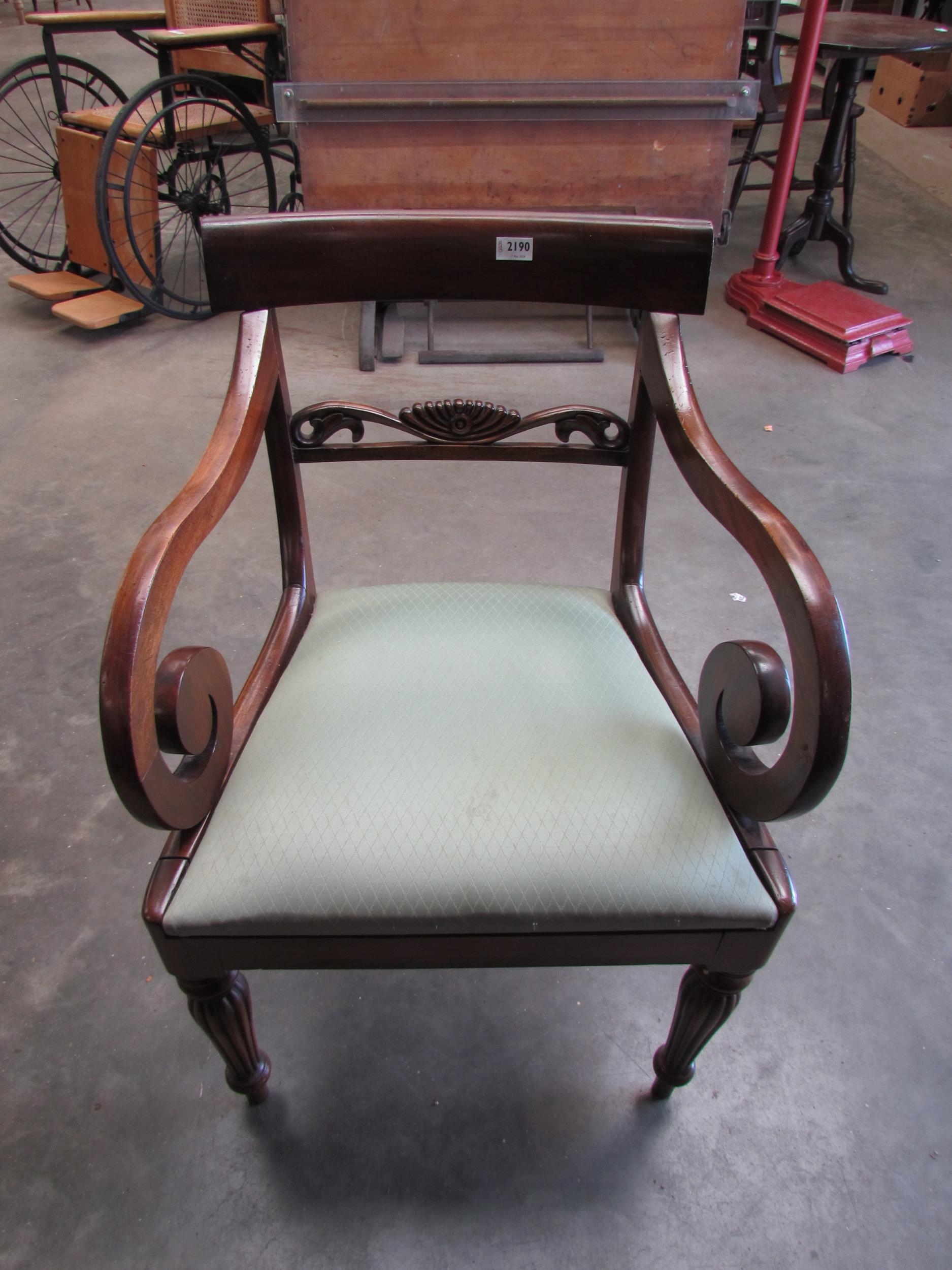 A Georgian mahogany scroll armed chair