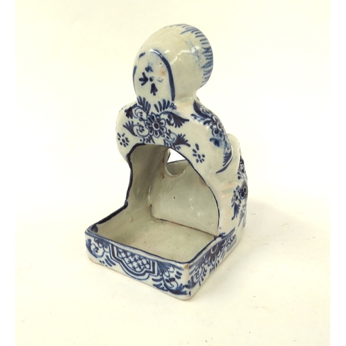 A late 19th century Dutch delft figurine with raised skirt and finger ...