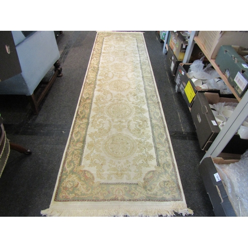 A silk cream ground runner rug with pale green border, 270cm x 76cm