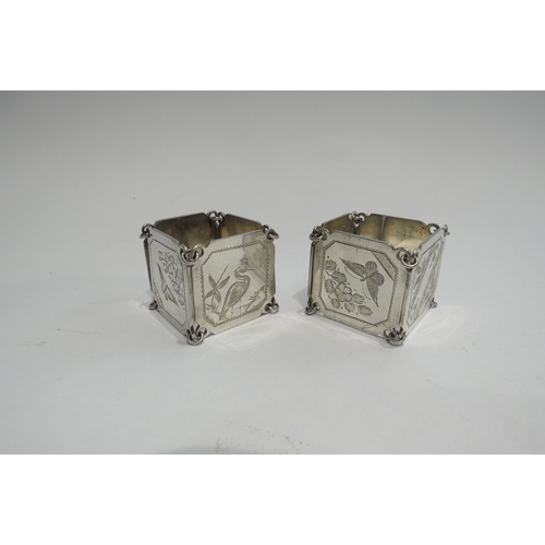 An unusual pair of silver-plated folding napkin rings decorated in the ...