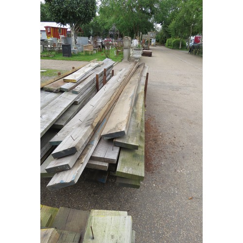 A metal stillage containing long reclaimed timber