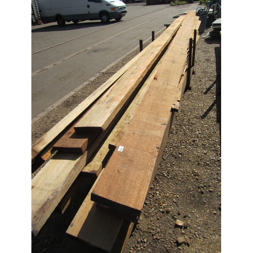 A metal stillage containing a quantity of long timber beams