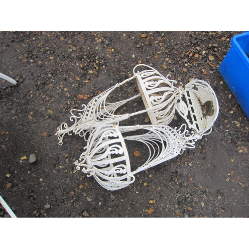 Two ornate metal hanging baskets and a cast wall mounted planter