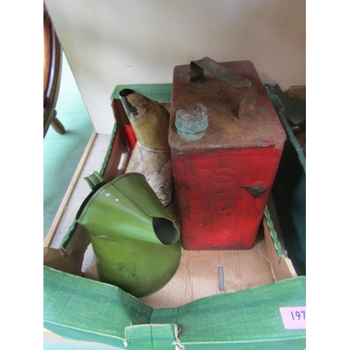 A Shell fuel can and three oil jugs