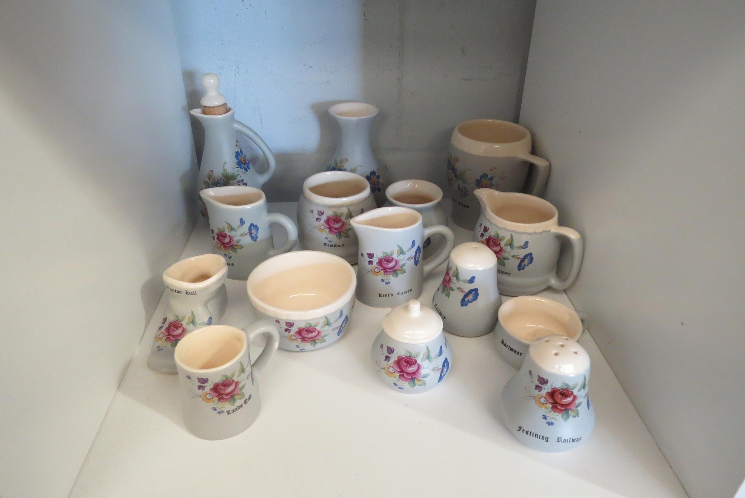 A collection of Buckfast Devon pottery including jugs, mugs, vase, salt ...