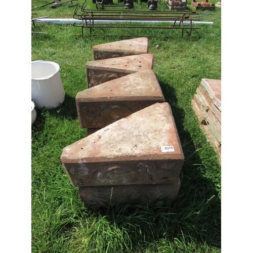 Eight decorative scrolled corner bricks