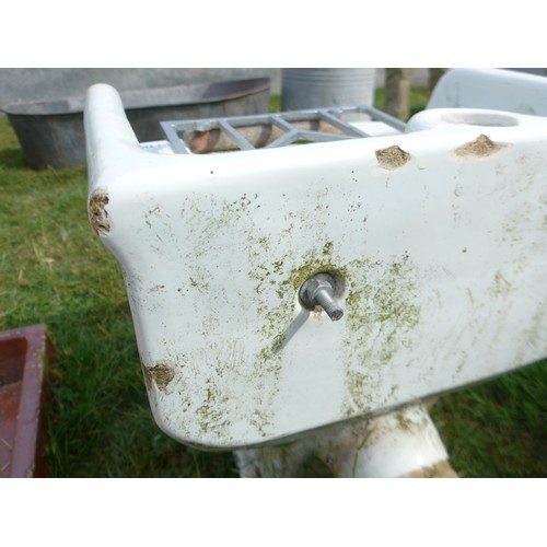 A glazed pedestal boot sink with chrome rack