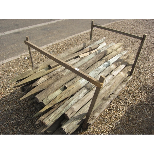 A quantity of round timber stakes