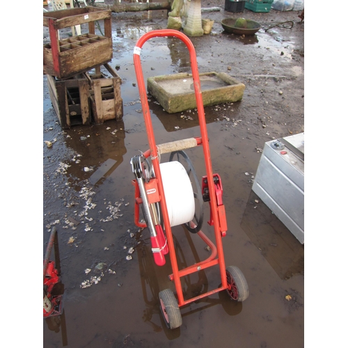 A banding trolley with banding tool and a roll of banding
