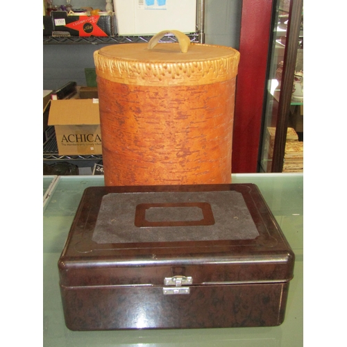 A wooden waste basket and bakelite box