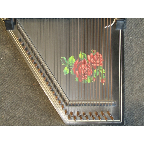 A vintage zither, ebonised case with rose design