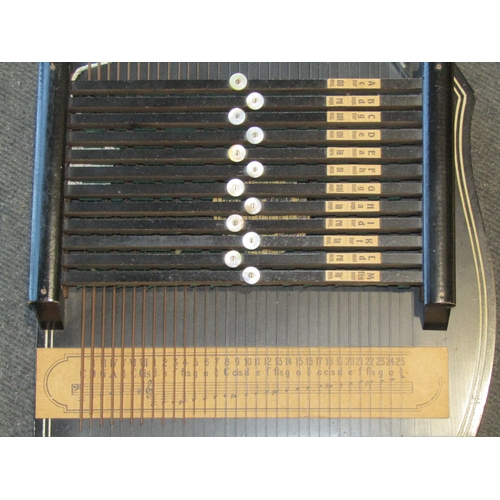 A vintage zither, ebonised case with rose design