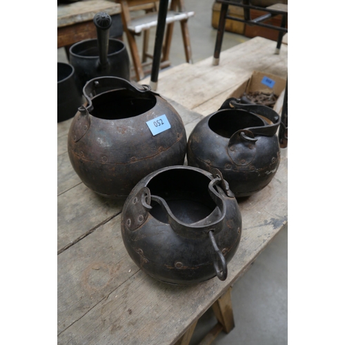 Three metal cauldrons