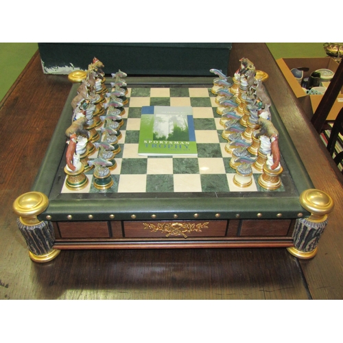 A Franklin Mint 'Sportsman Trophy' chess set, boxed, together with a ...