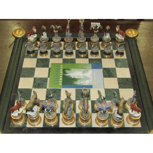A Franklin Mint 'Sportsman Trophy' chess set, boxed, together with a ...