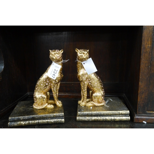 A pair of cheetah bookends with pink spots