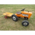 A Triang Ploughman plastic pedal tractor with pressed steel trailer