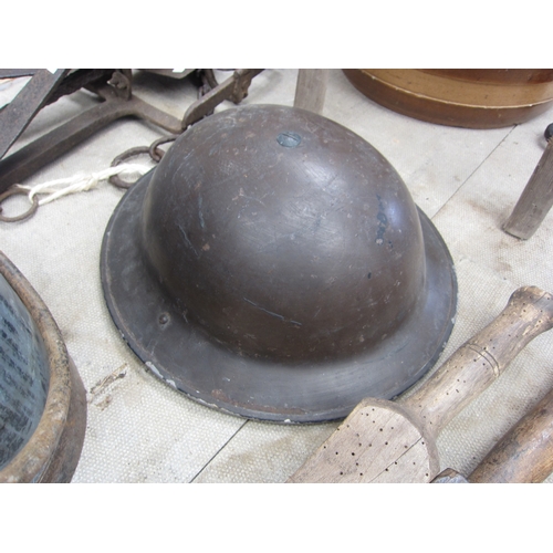 A WWII tin helmet dated 1939 with chin strap