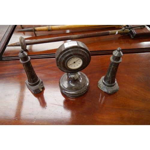 A Cornish granite clock with a matching pair of light houses