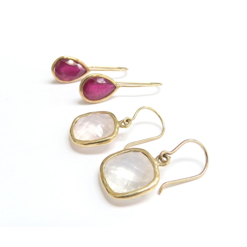 A pair of gold facet cut ruby earrings and a pair of facet cushion cut ...
