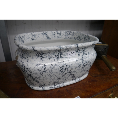 A Victorian marbled ceramic pottery foot bath, one handle off