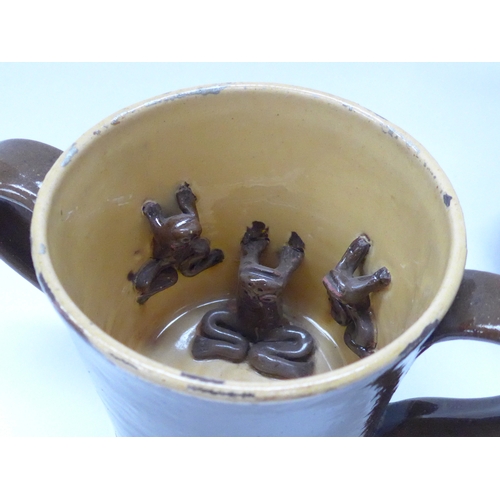 Two c1970's studio pottery slipware items including 'frog' mug and a ...