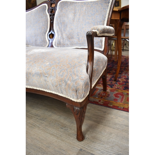 A late Victorian mahogany two seater sofa with carved fretwork ...