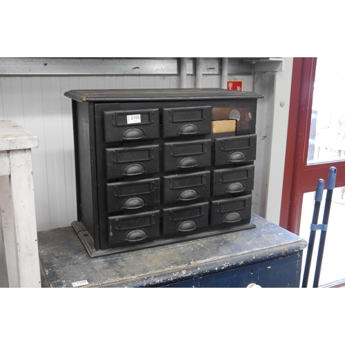A small oak cupboard made to look like a bank of drawers
