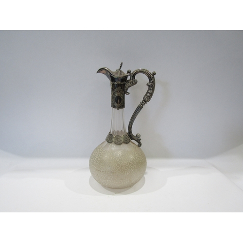 A late Victorian glass shaft and globe claret jug, with wriggle work ...