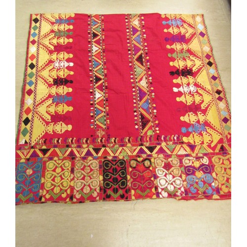 A Middle Eastern silk embroidered cloth in vibrant colours, possibly ...
