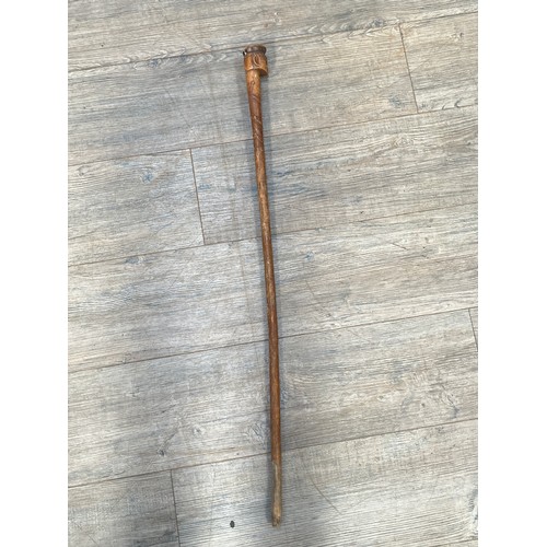 A prisoner of war carved walking stick with soldier head knop