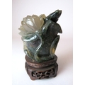 A Chinese carved jade lotus flower with frog to rim rim on hardwood ...