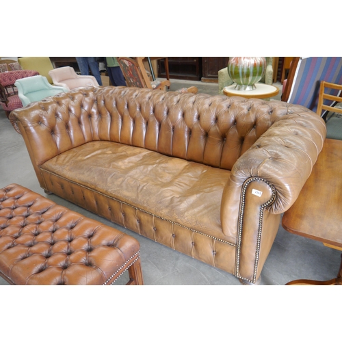 A well worn brown button leather Chesterfield pub sofa