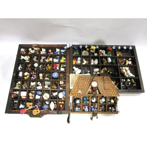 Two small display stands containing a quantity of miniature collectables