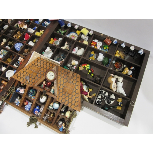 Two small display stands containing a quantity of miniature collectables