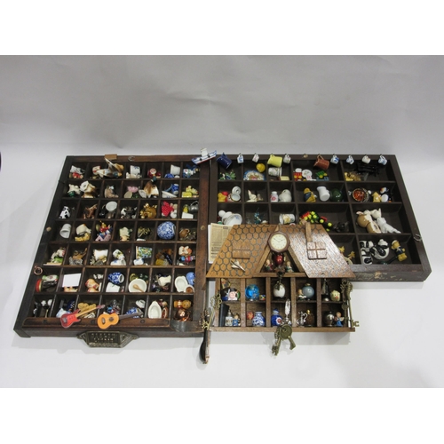 Two small display stands containing a quantity of miniature collectables