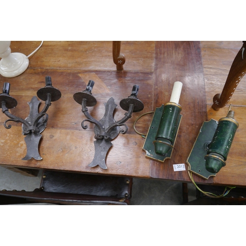 A pair of tole ware wall lights and two wrought iron examples