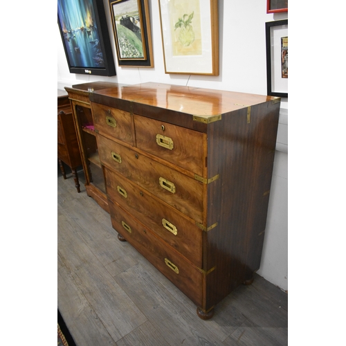 A circa 1900 campaign chest of two over three drawers with brass inset ...