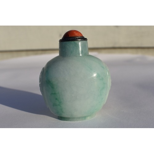 An early 19th Century snuff bottle, carved in very low relief at each ...