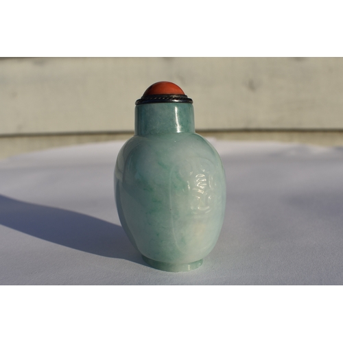 An early 19th Century snuff bottle, carved in very low relief at each ...