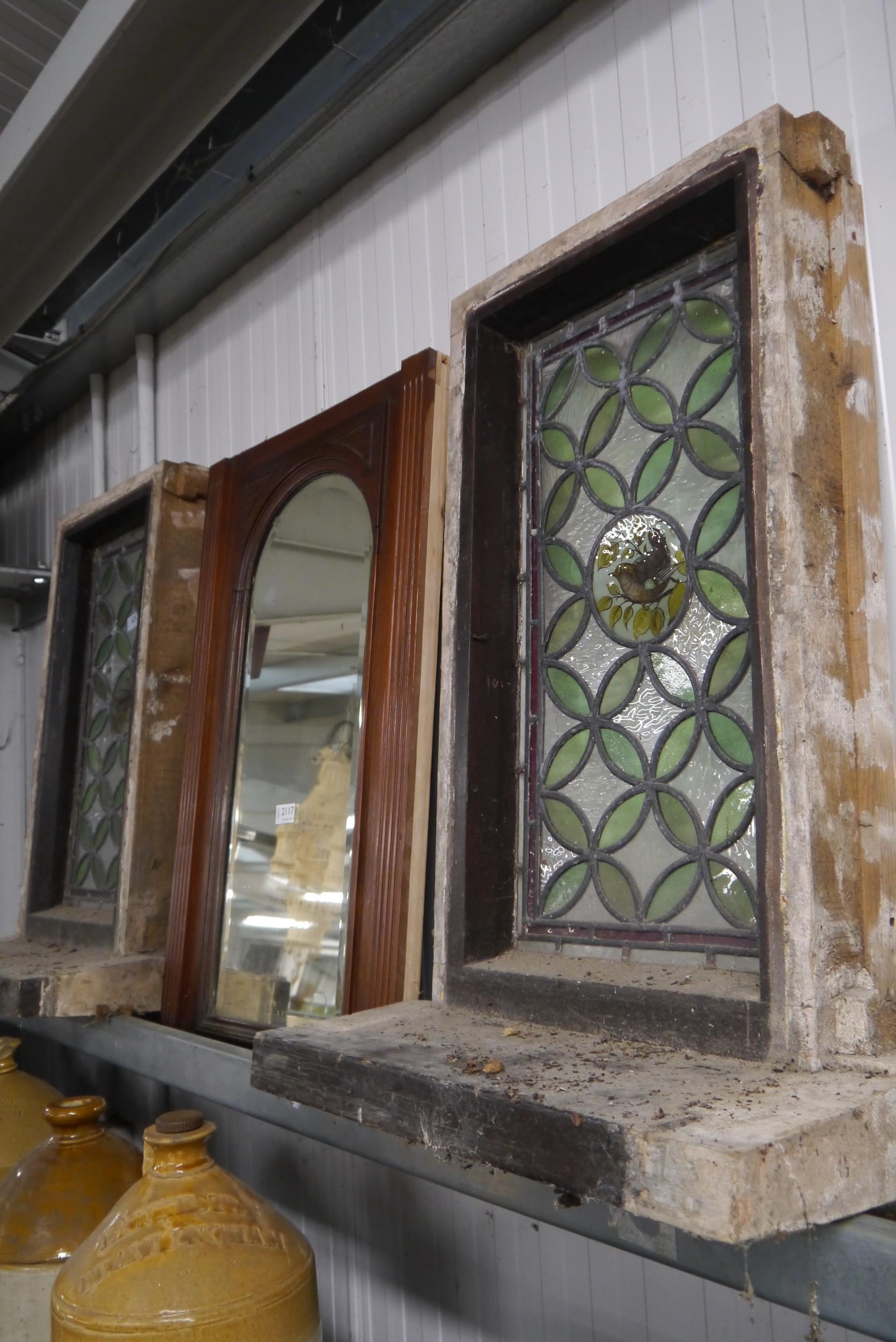 A pair of stained window lights with wren centre, in frames